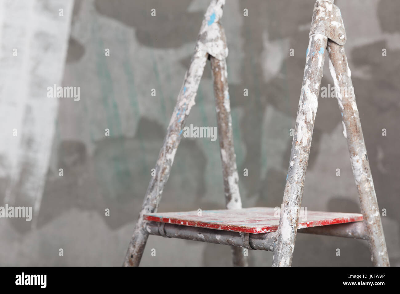Old painted and stucco ladder on concrete wall background Stock Photo ...