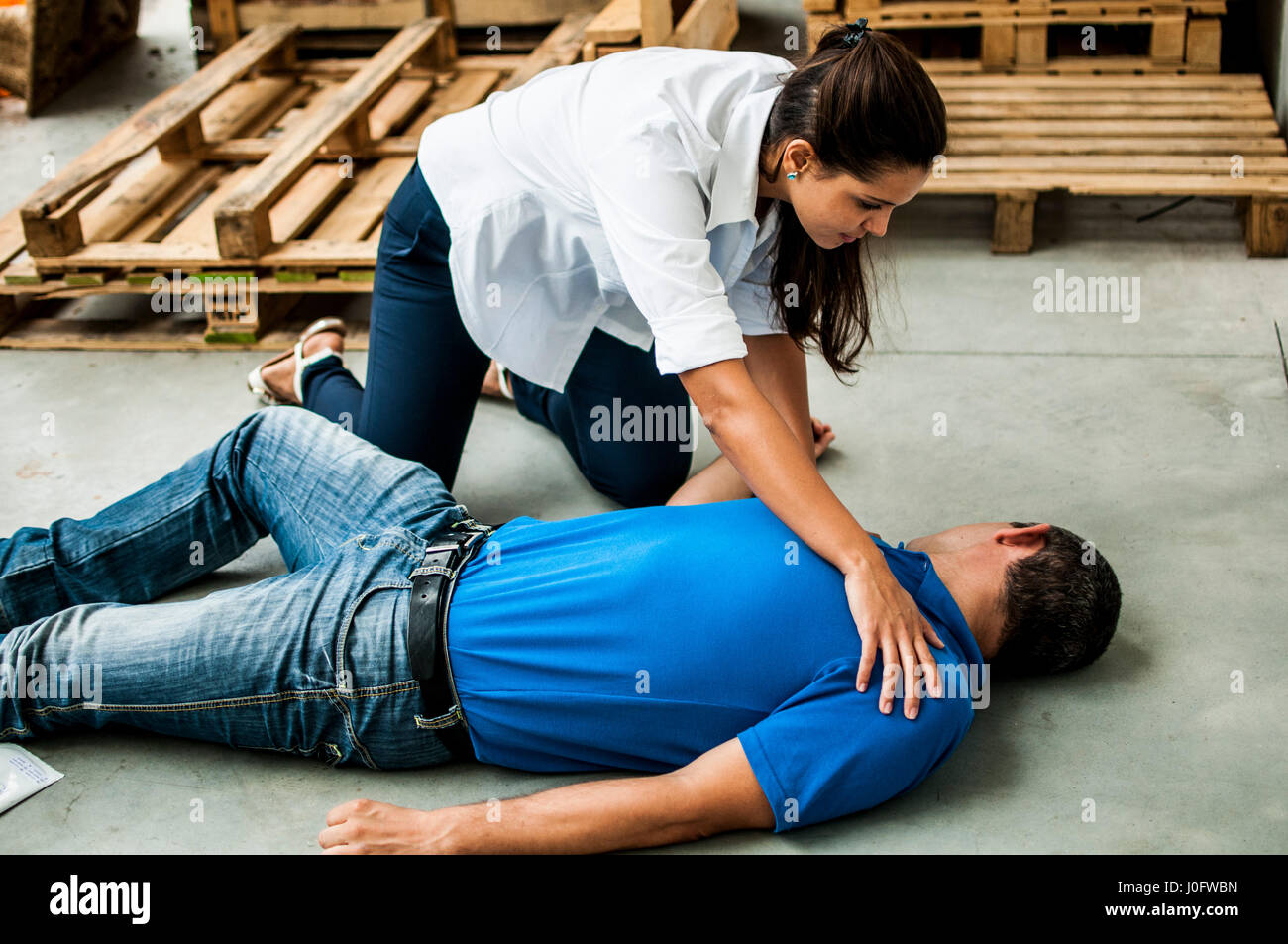 a girl helping a guy after heart attack with cardiopulmonary ...