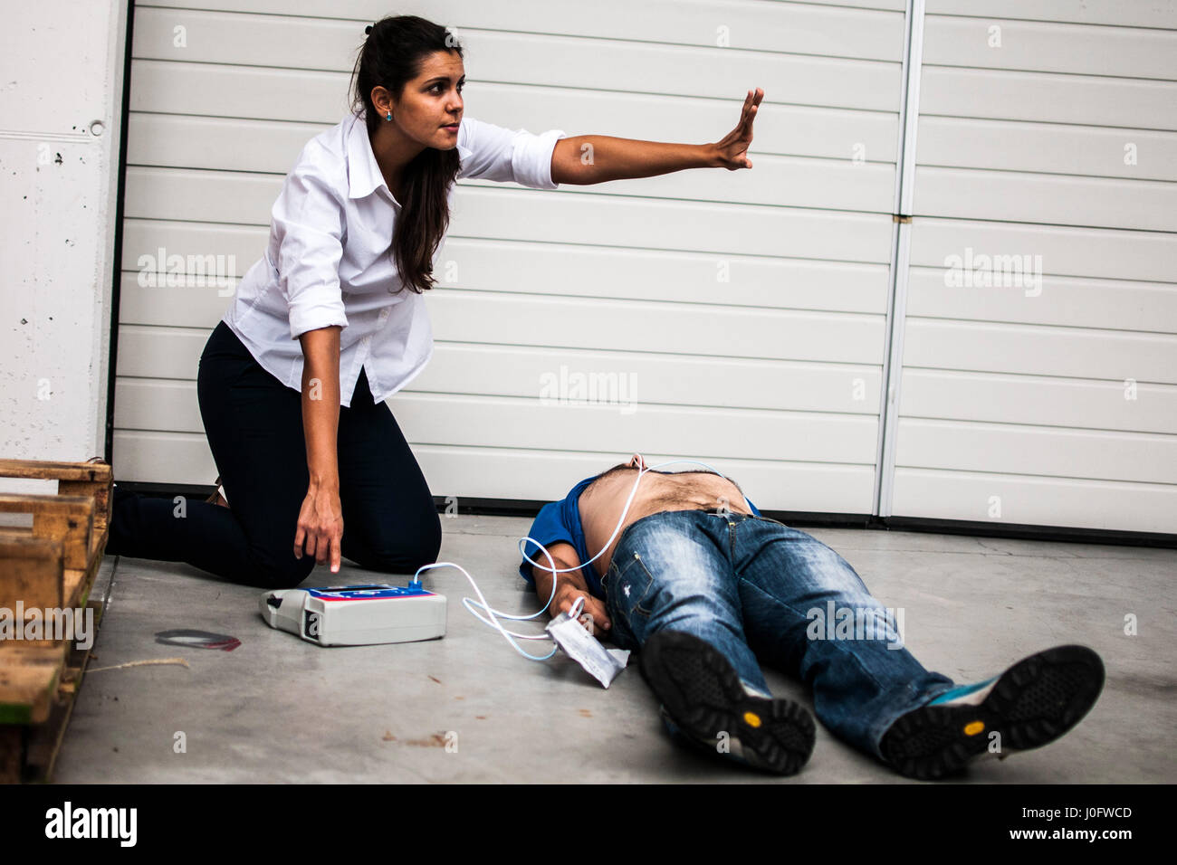 a girl helping a guy after heart attack with cardiopulmonary ...