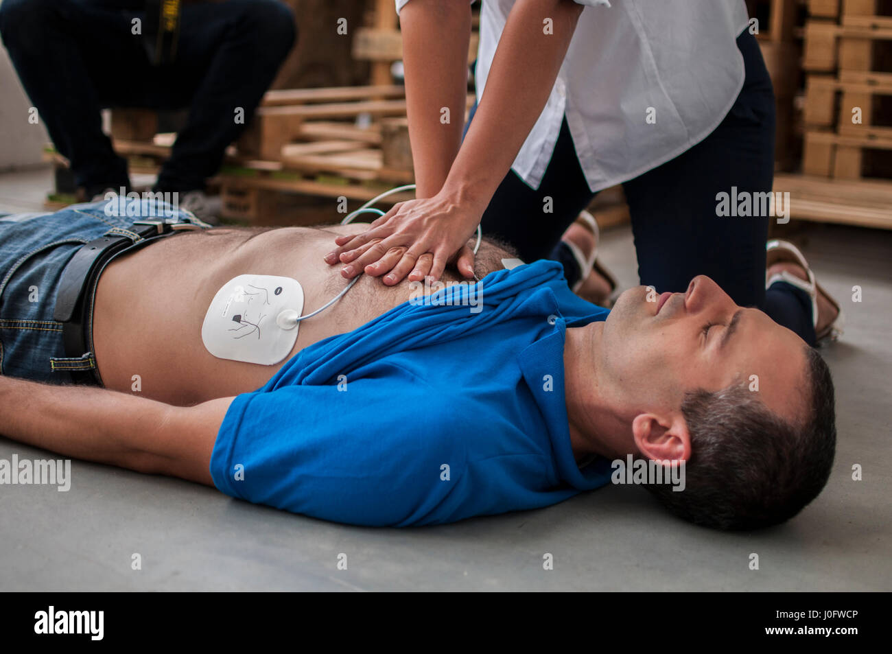 a girl helping a guy after heart attack with cardiopulmonary ...