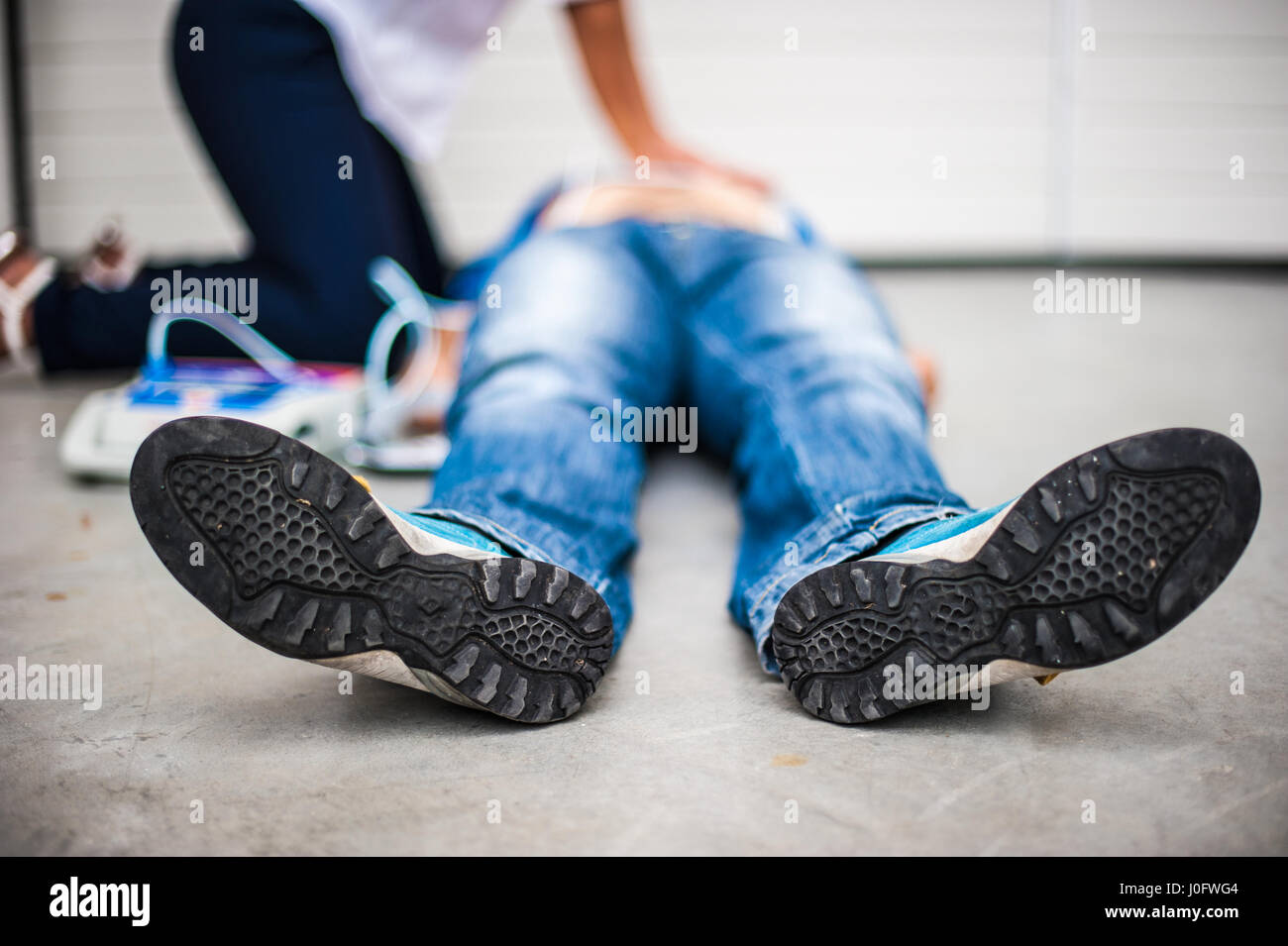 a girl helping a guy after heart attack with cardiopulmonary ...