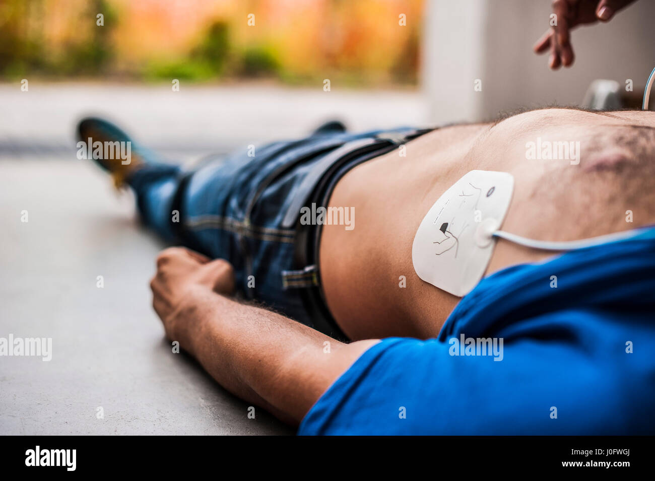 a girl helping a guy after heart attack with cardiopulmonary ...