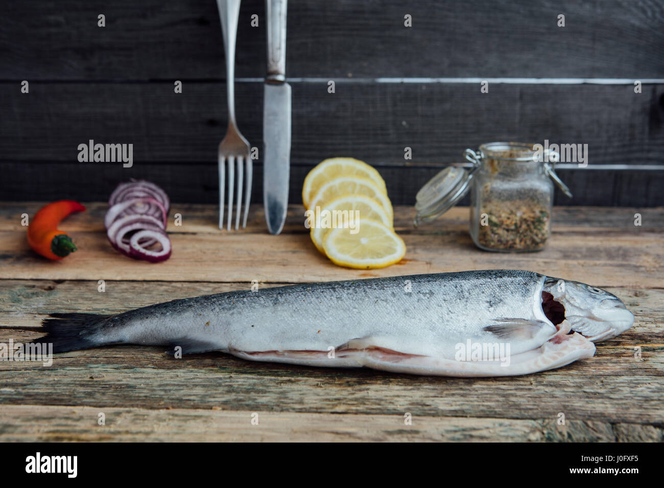 fresh fish ready to be cook on a wooden table Stock Photo - Alamy