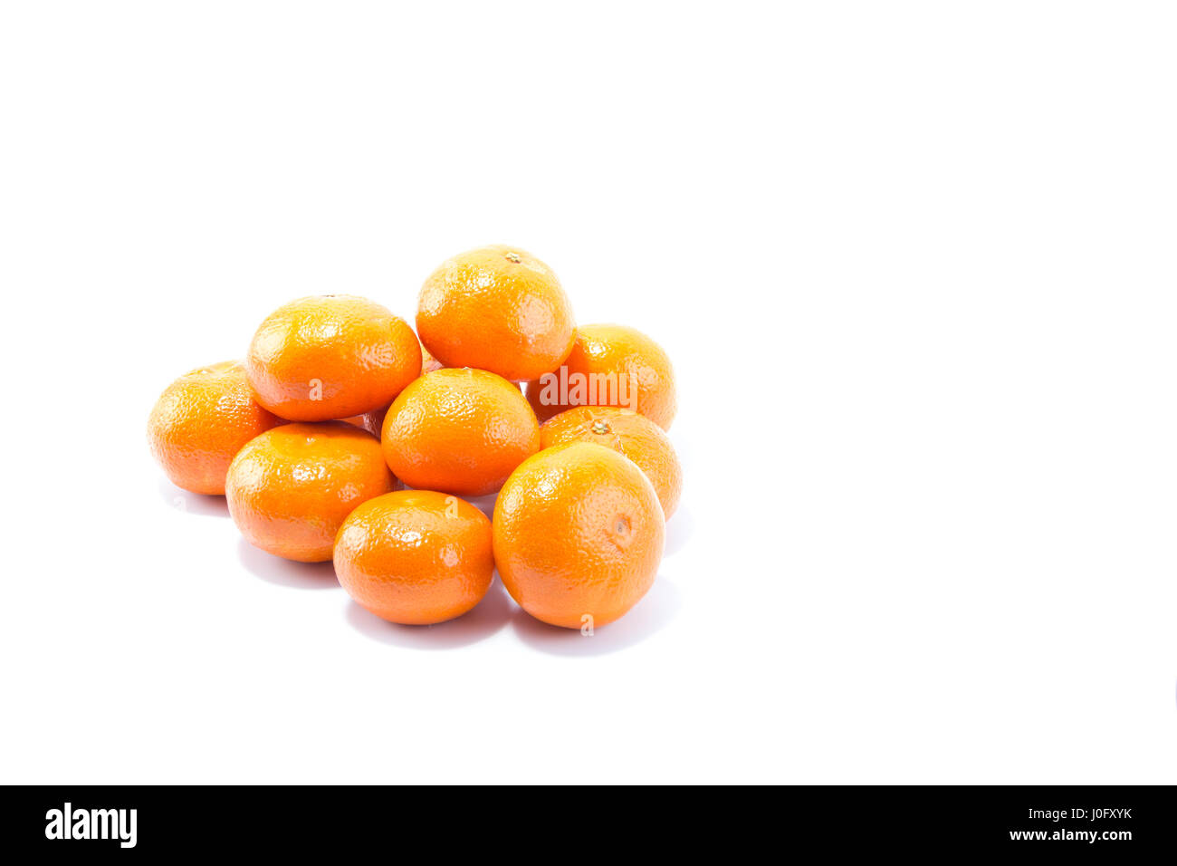 Fresh stack of shinning orange mandarins isolated in white background ...