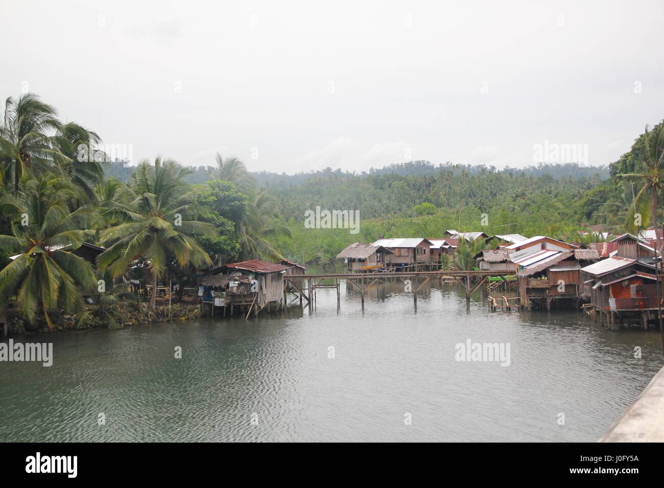 Houses by the riverside, Southern Philippines Houses on stilts in a ...