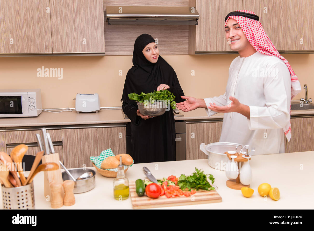 Young arab family in the kitchen Stock Photo - Alamy