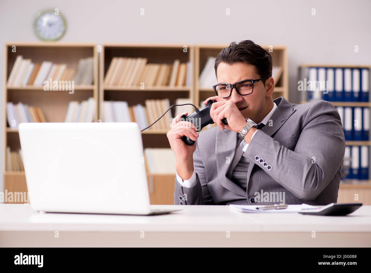 Businessman playing computer games at work office Stock Photo - Alamy