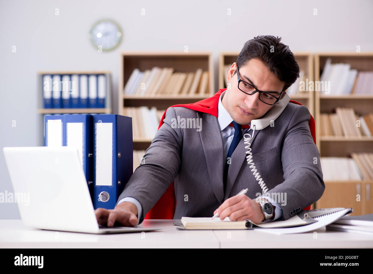 Superhero businessman working in the office Stock Photo - Alamy