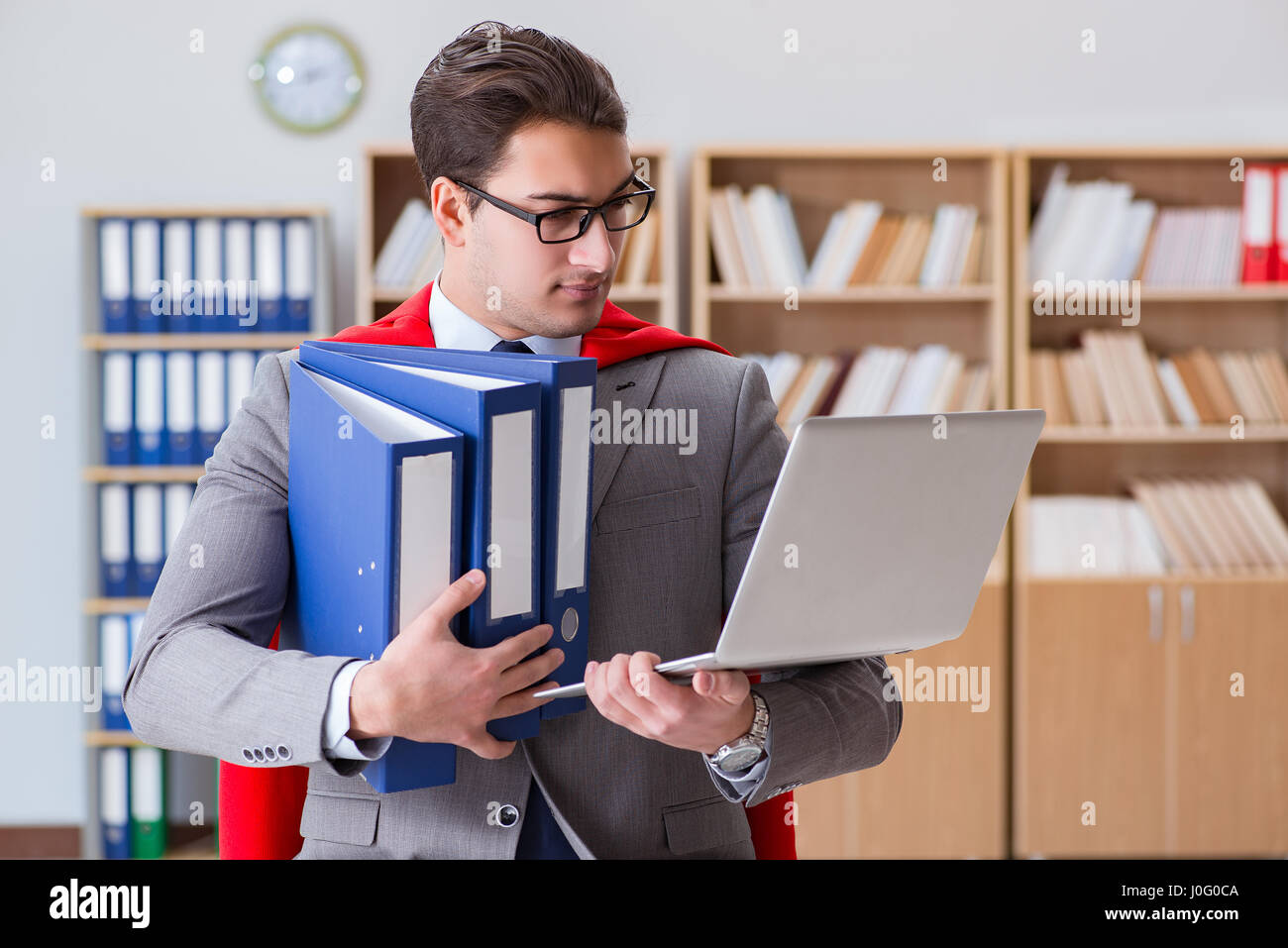 Superhero businessman working in the office Stock Photo - Alamy
