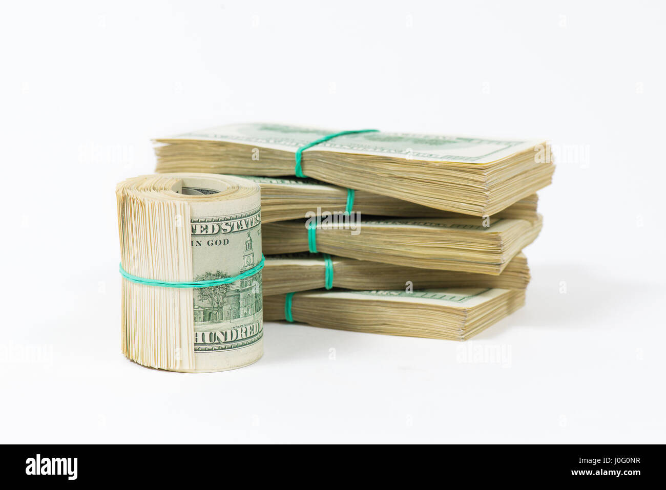 A twisted bundle of 100 dollar bills stands on packs of dollars Stock ...