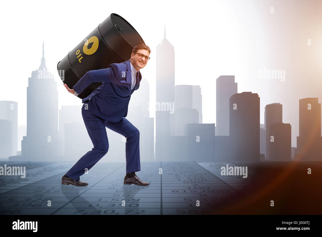 Businessman under the burden of oil barrel Stock Photo - Alamy