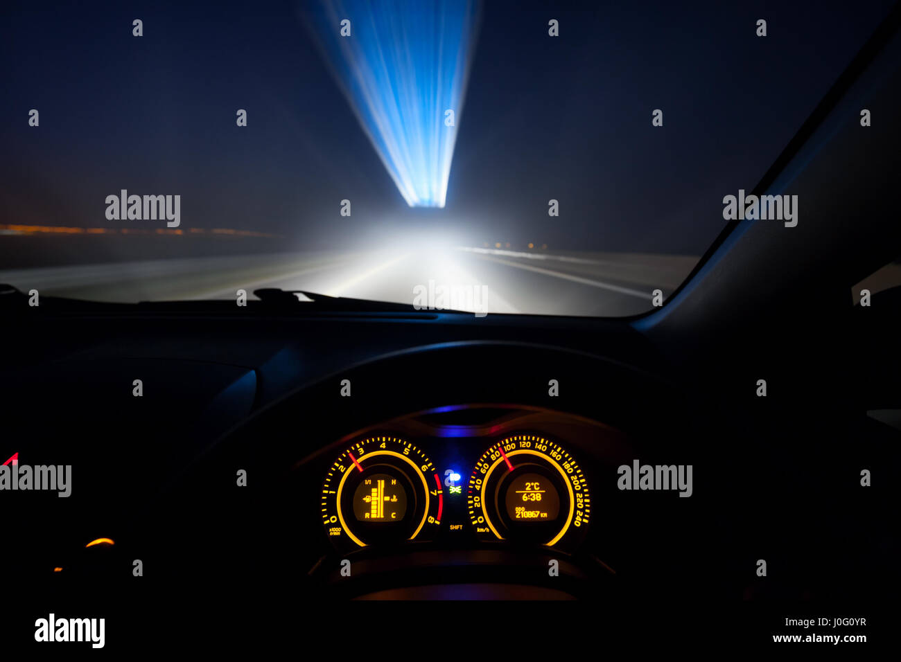 Driver view at speeding car dashboard and motorway at night Stock Photo ...