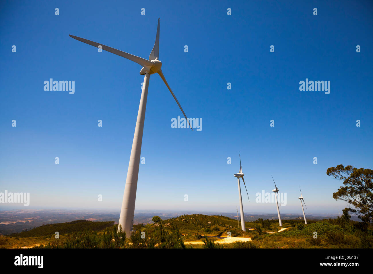 Wind Turbine power generators on the mountain during sunny day Stock ...
