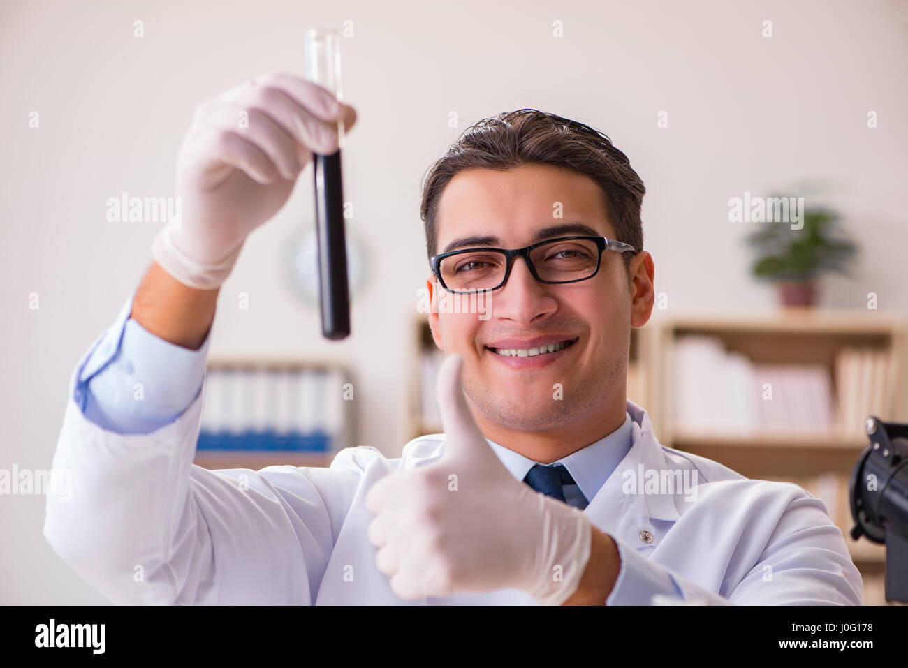 Young lab assistan working in the laboratory Stock Photo - Alamy