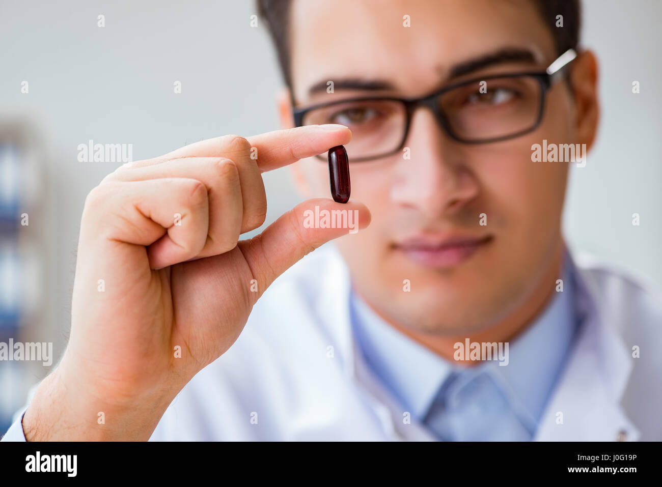 Doctor holding medicines in the lab Stock Photo - Alamy