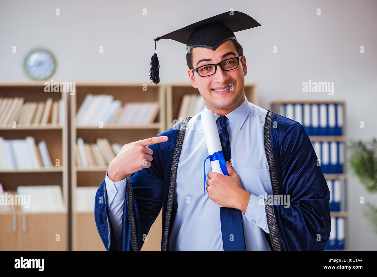 Young man graduating from university Stock Photo - Alamy
