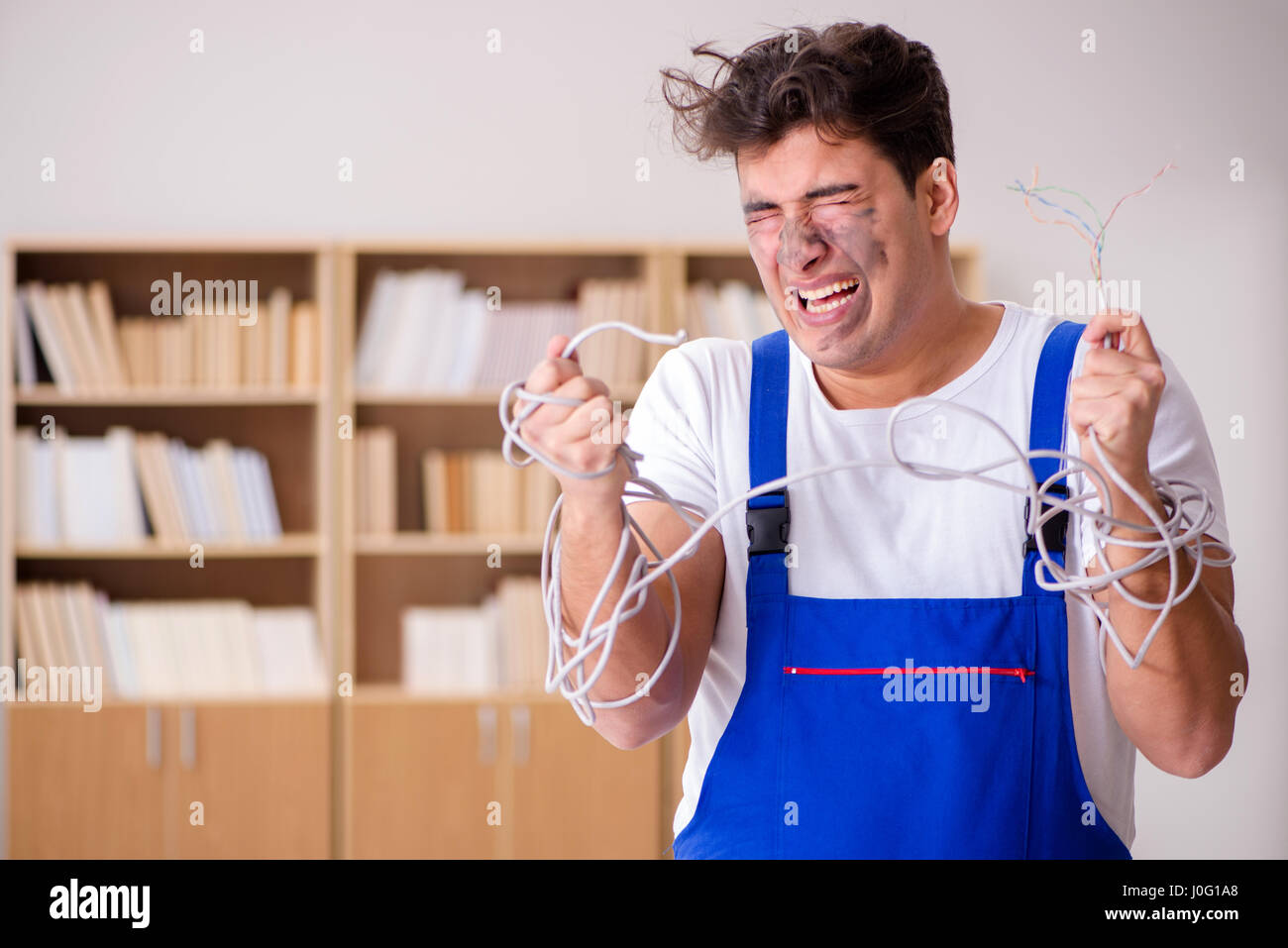 Funny Man doing electrical repairs at home Stock Photo - Alamy