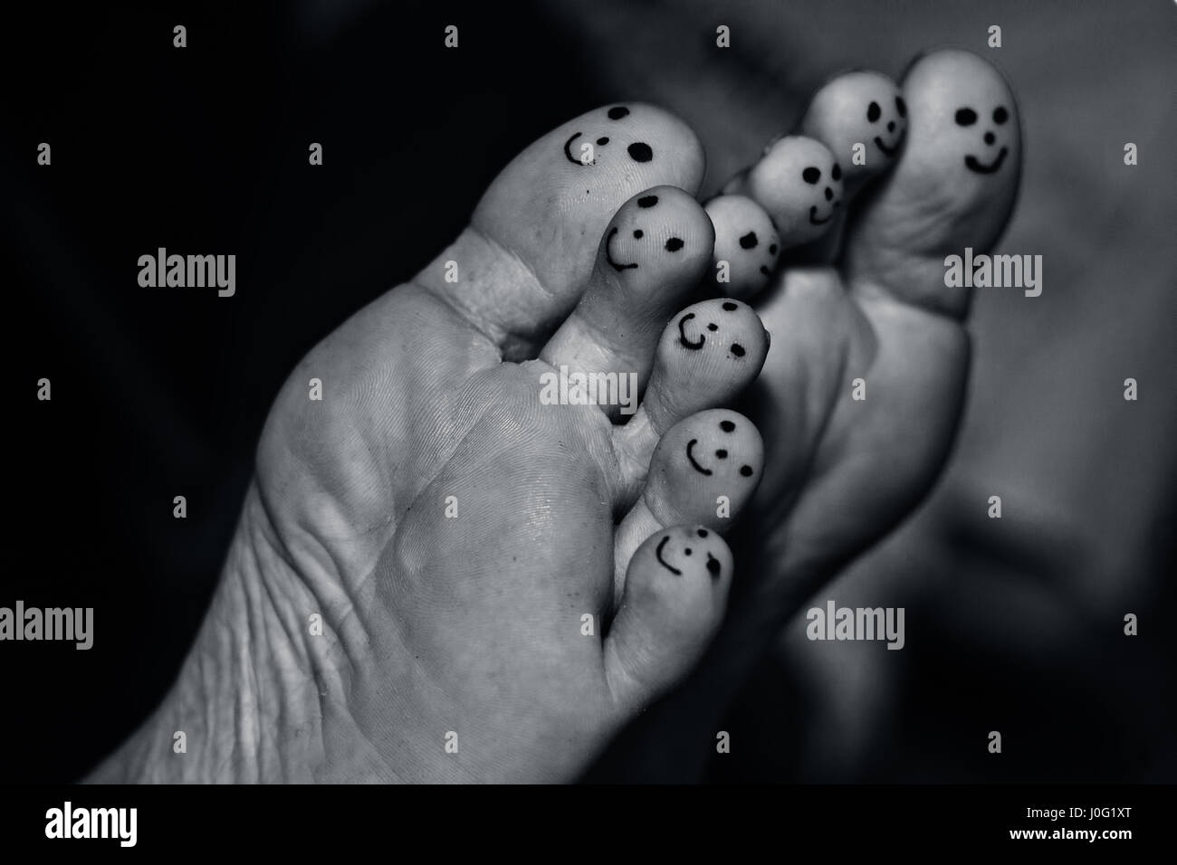 all ten toes of feet with smiley faces drawn with black pen Stock Photo ...