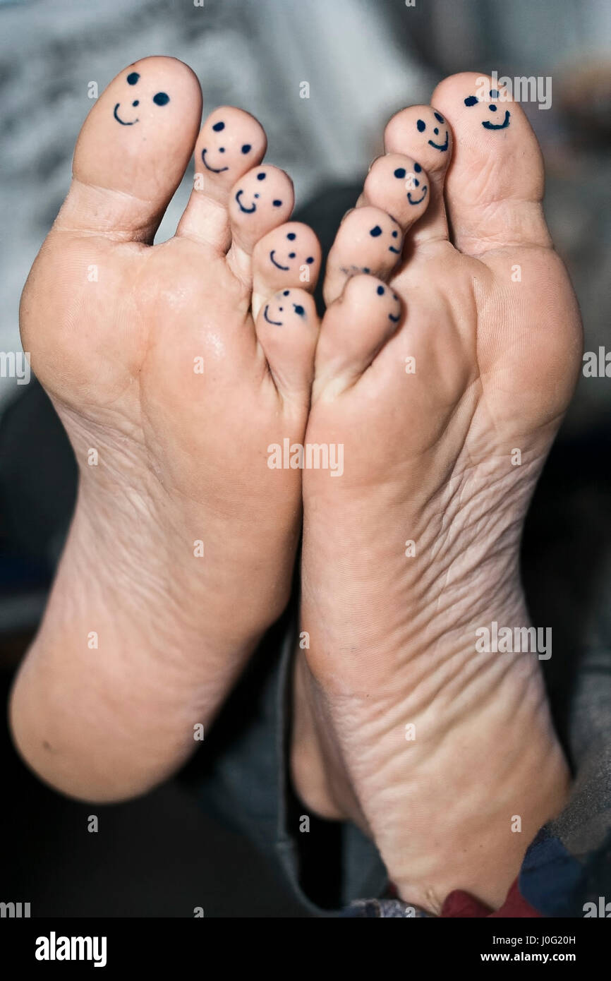 all ten toes of feet with smiley faces drawn with black pen Stock Photo ...