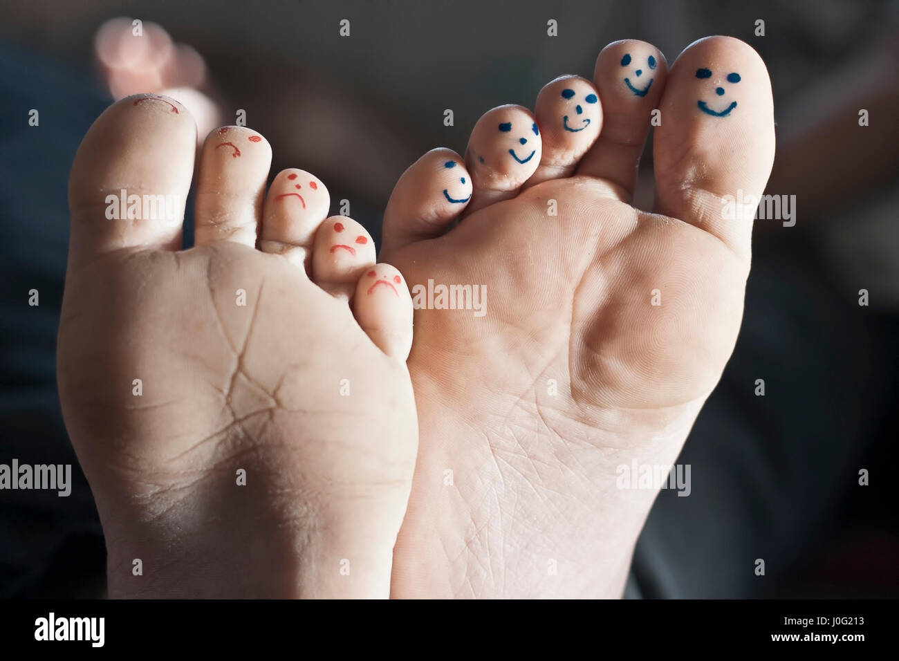 all ten toes of feet with smiley faces drawn with black pen Stock Photo ...