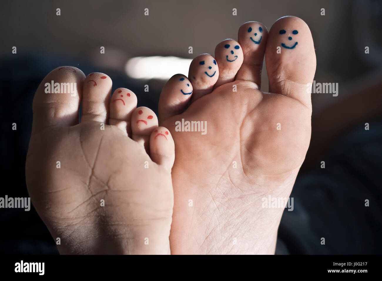 all ten toes of feet with smiley faces drawn with black pen Stock Photo ...