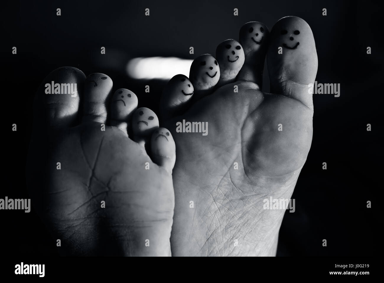 all ten toes of feet with smiley faces drawn with black pen Stock Photo ...