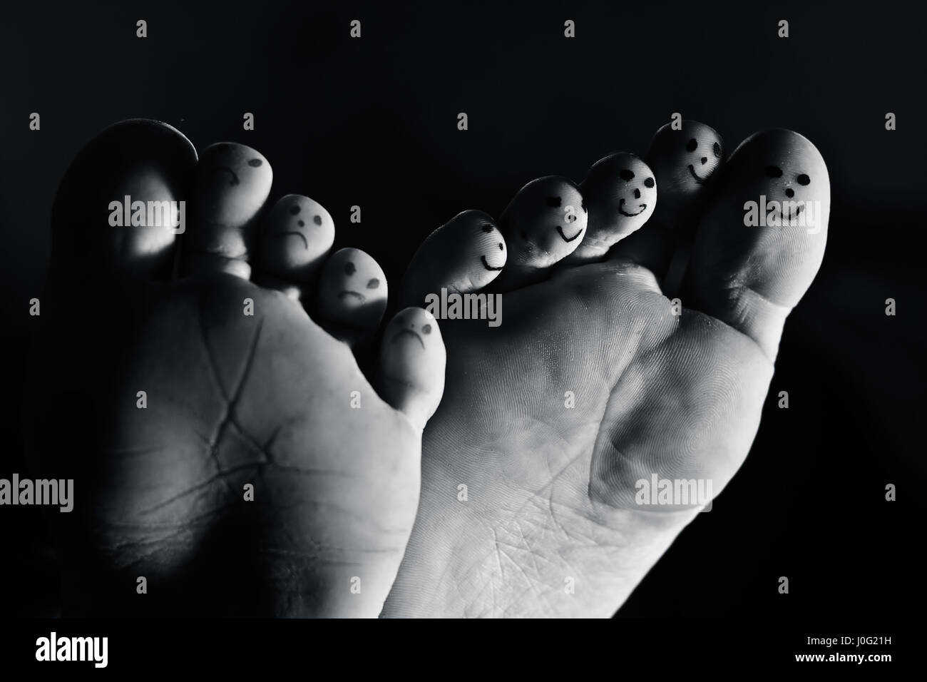 all ten toes of feet with smiley faces drawn with black pen Stock Photo ...