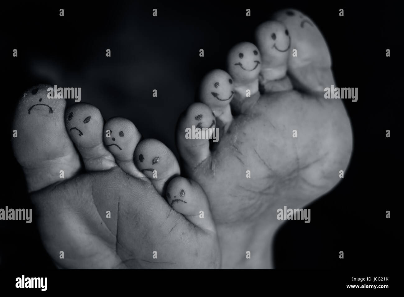 all ten toes of feet with smiley faces drawn with black pen Stock Photo ...
