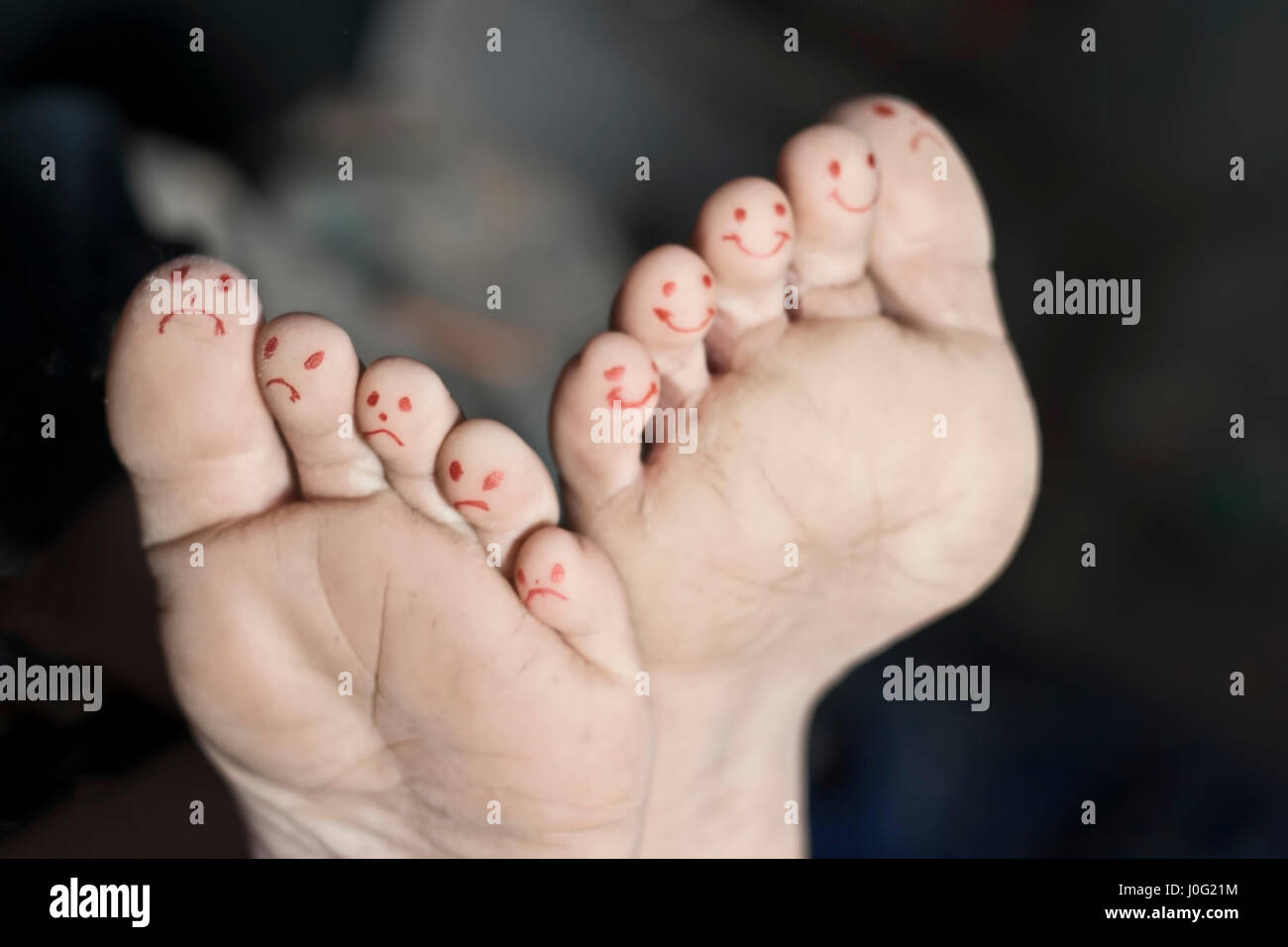 all ten toes of feet with smiley faces drawn with black pen Stock Photo ...