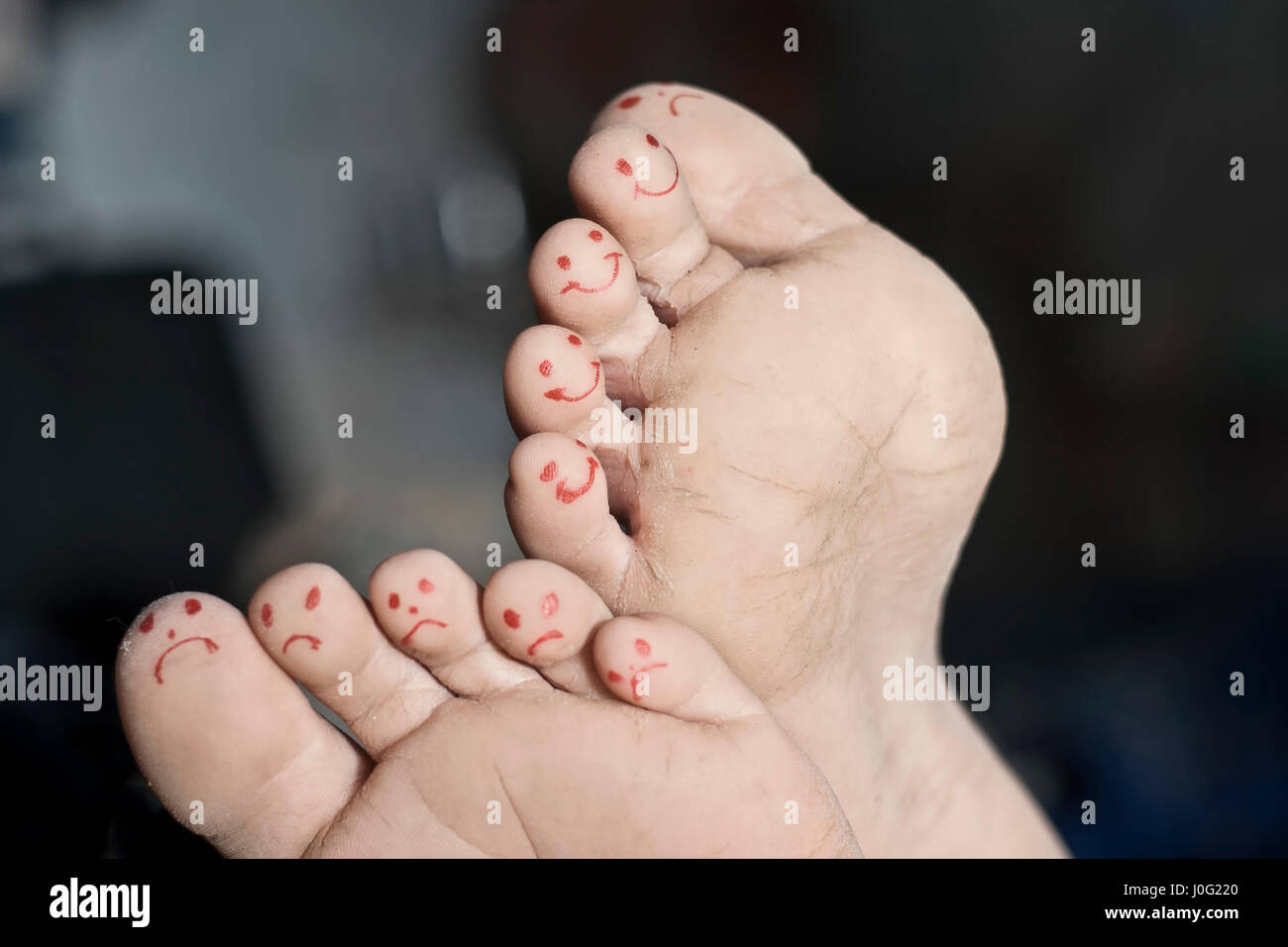 all ten toes of feet with smiley faces drawn with black pen Stock Photo ...