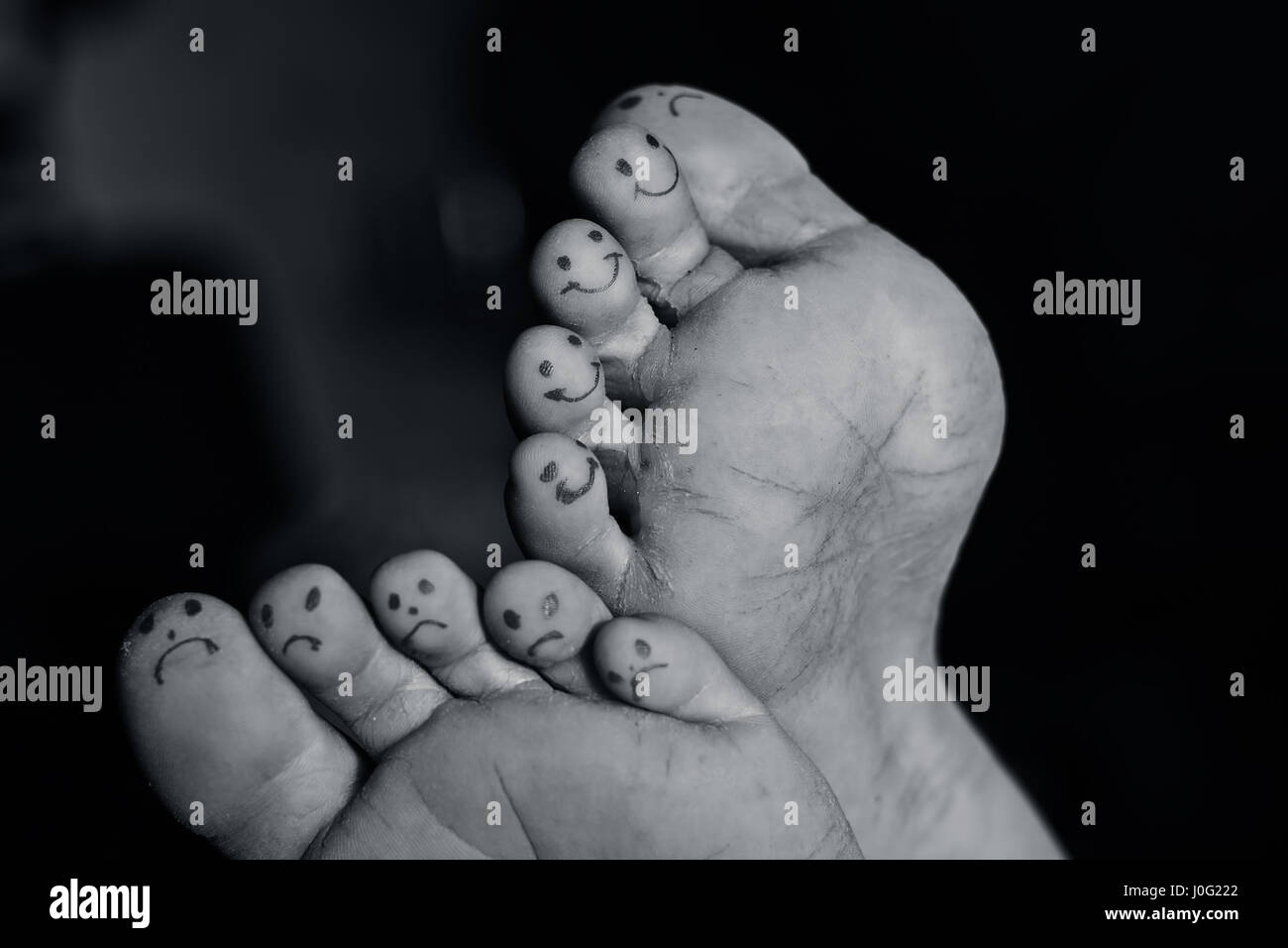 all ten toes of feet with smiley faces drawn with black pen Stock Photo ...