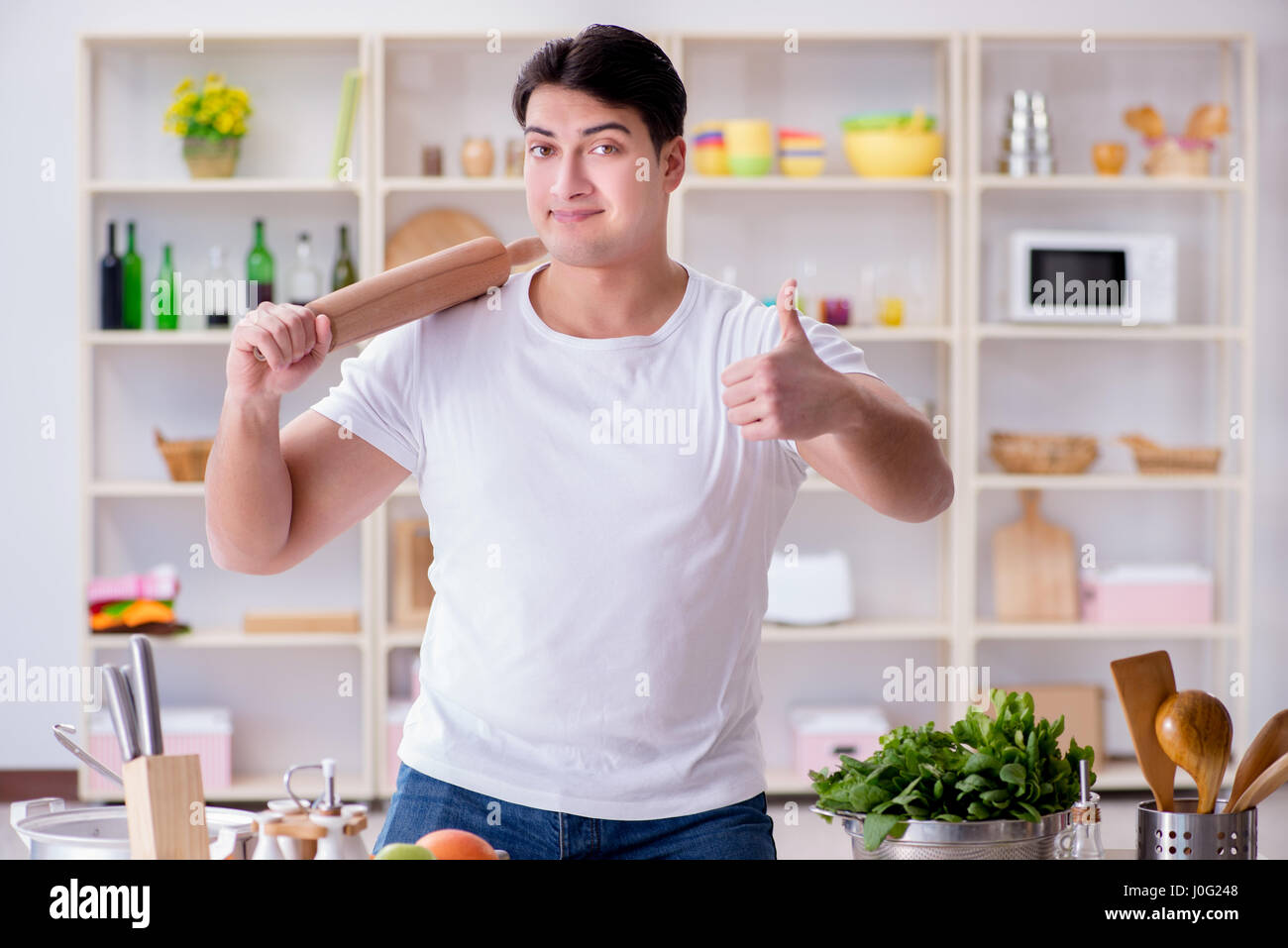 Young male cook working in the kitchen Stock Photo - Alamy