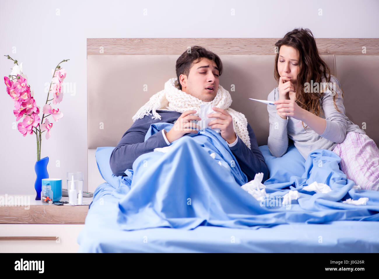 Wife caring for sick husband at home in bed Stock Photo - Alamy