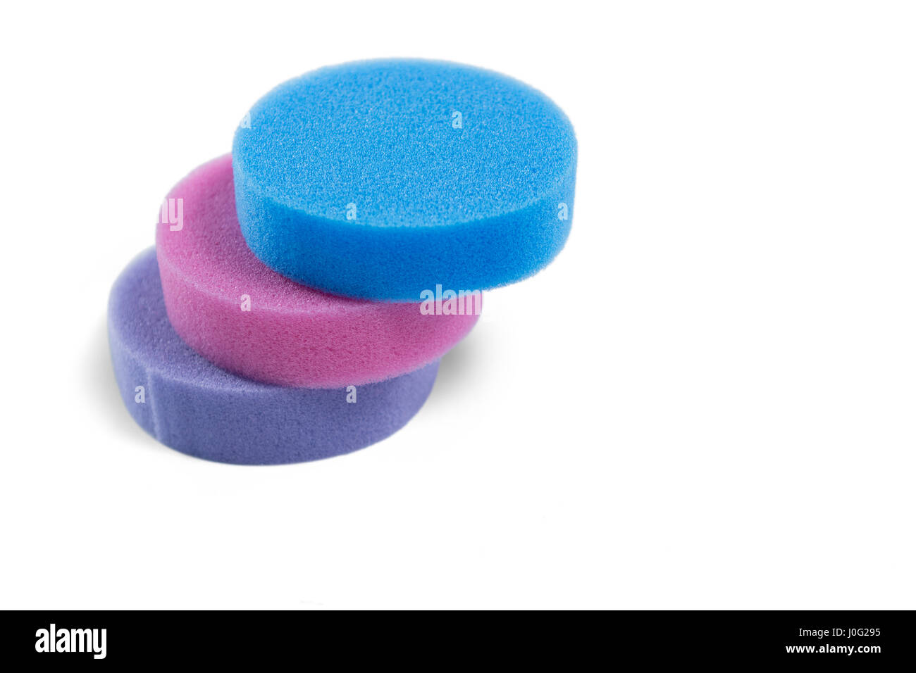 Close up of multi colored sponge against white background Stock Photo ...