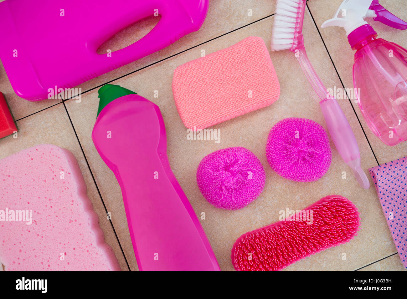 Close up of pink cleaning products on tiled floor Stock Photo - Alamy