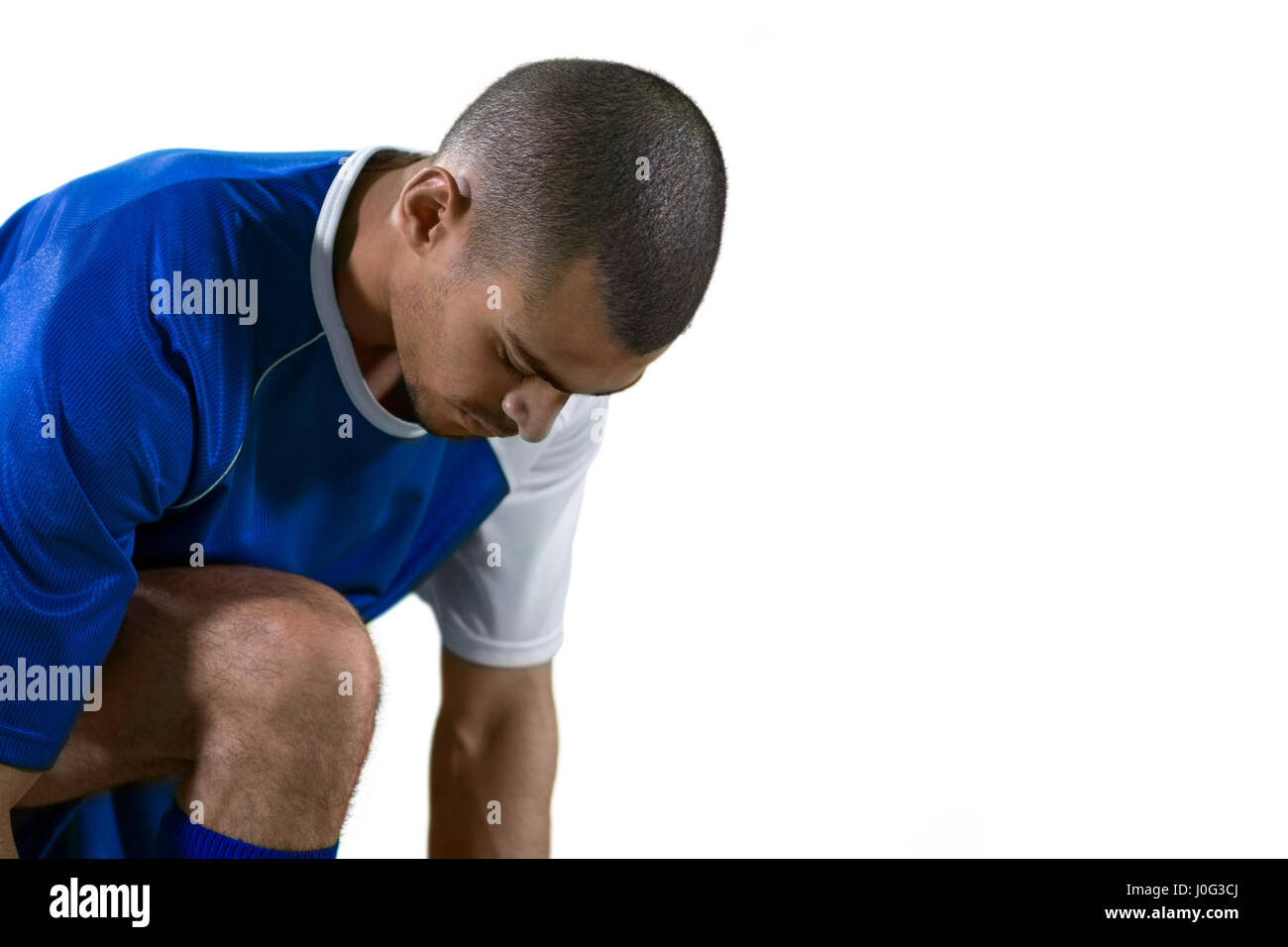 Football player getting ready for the game against white background ...