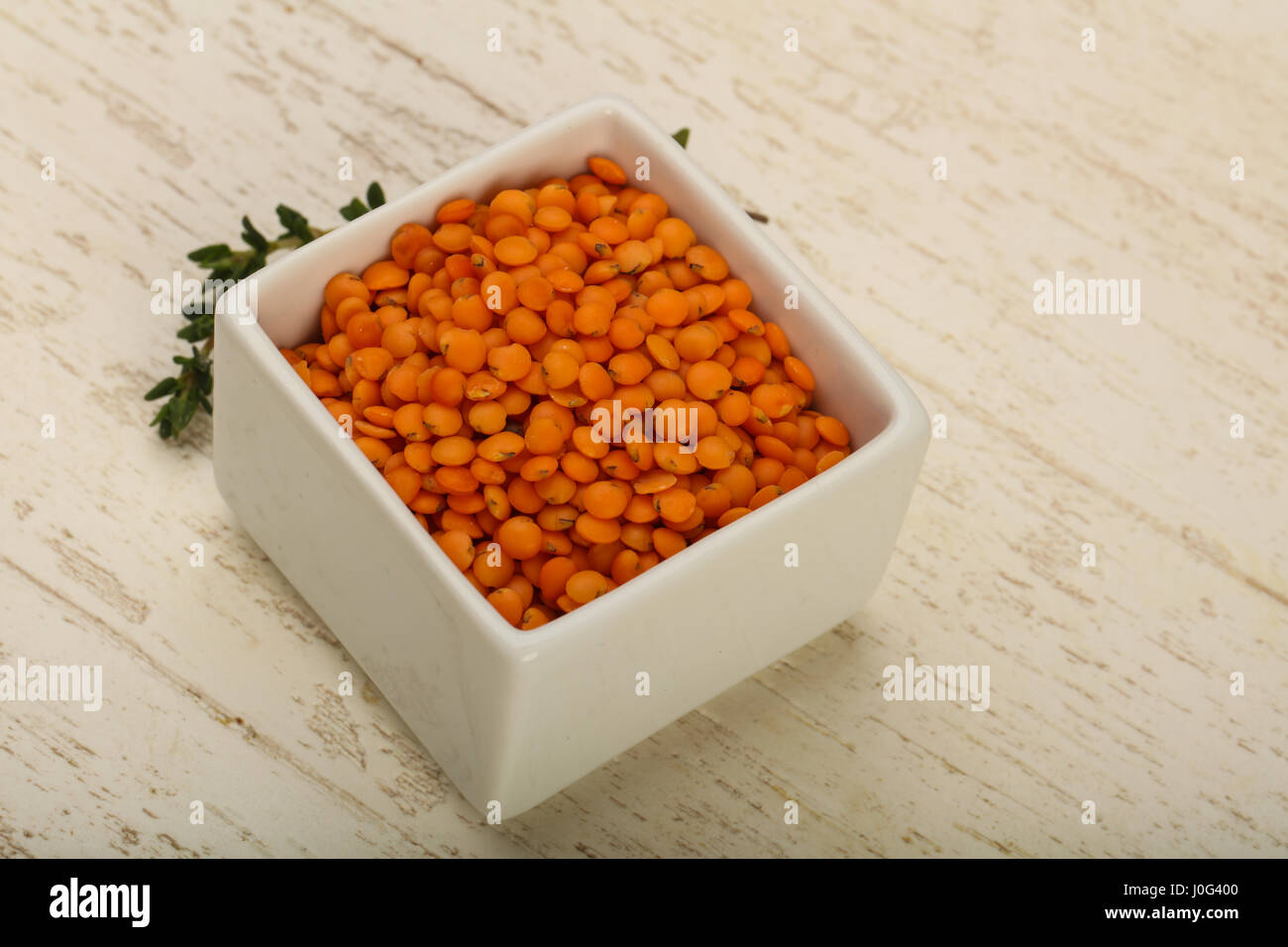 Orange lentil in the bowl over wooden background Stock Photo - Alamy