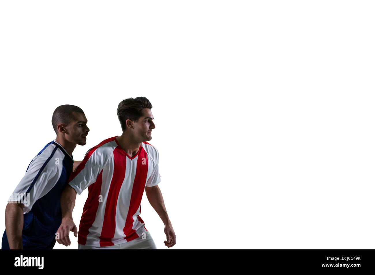 Two football players defending each other while playing soccer against ...