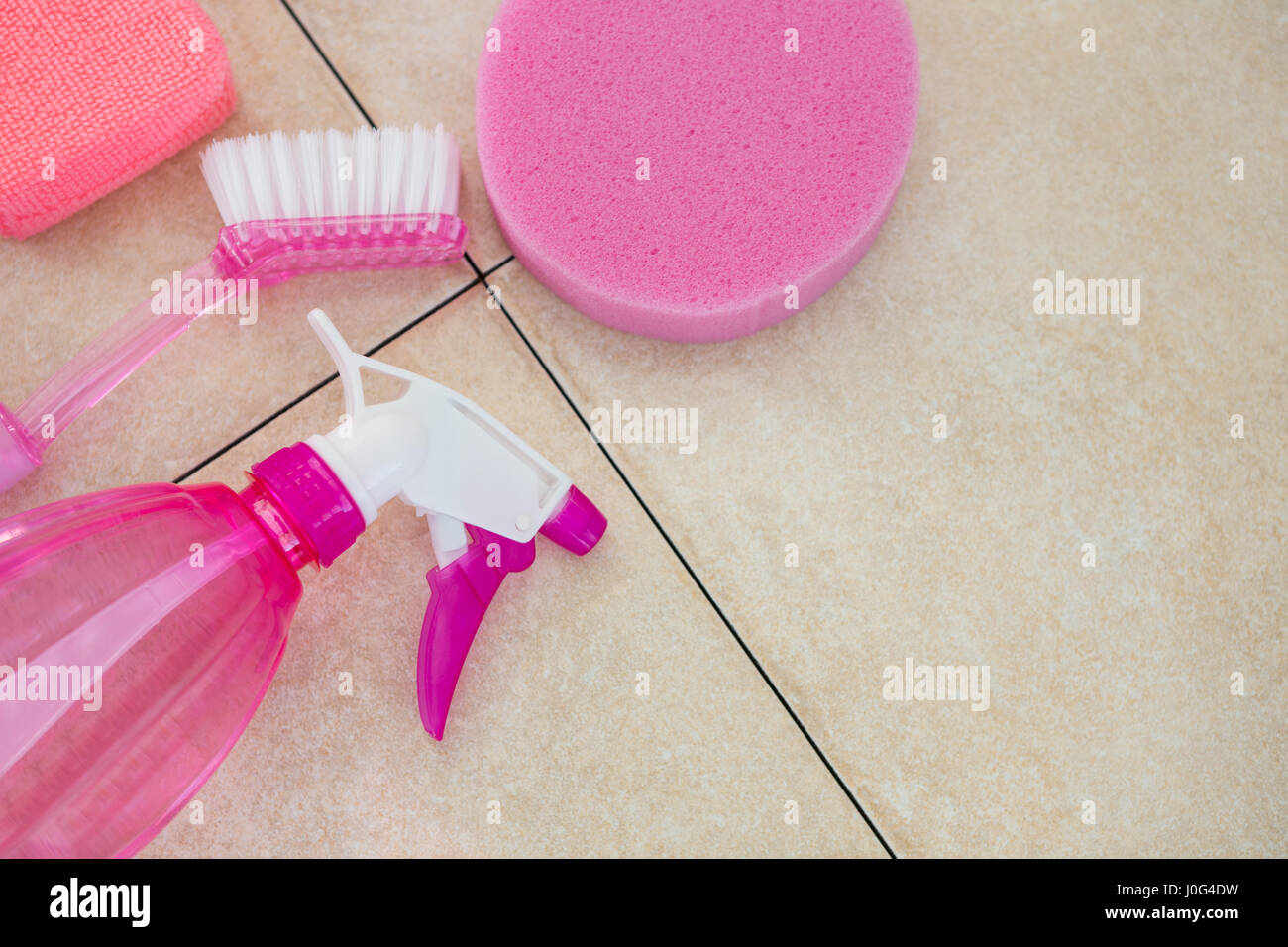 Close up of pink cleaning equipment on tiled floor Stock Photo - Alamy