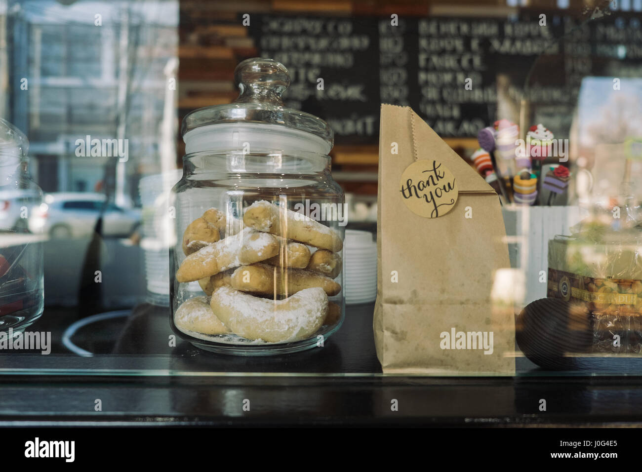 Cookies and paper packing in cafe showcase Stock Photo - Alamy