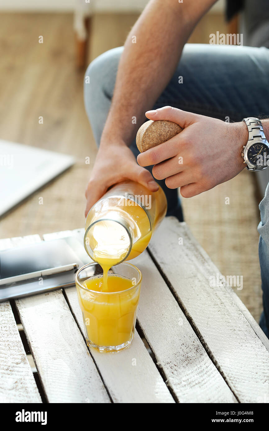 Drink. Man pours fresh juice Stock Photo - Alamy