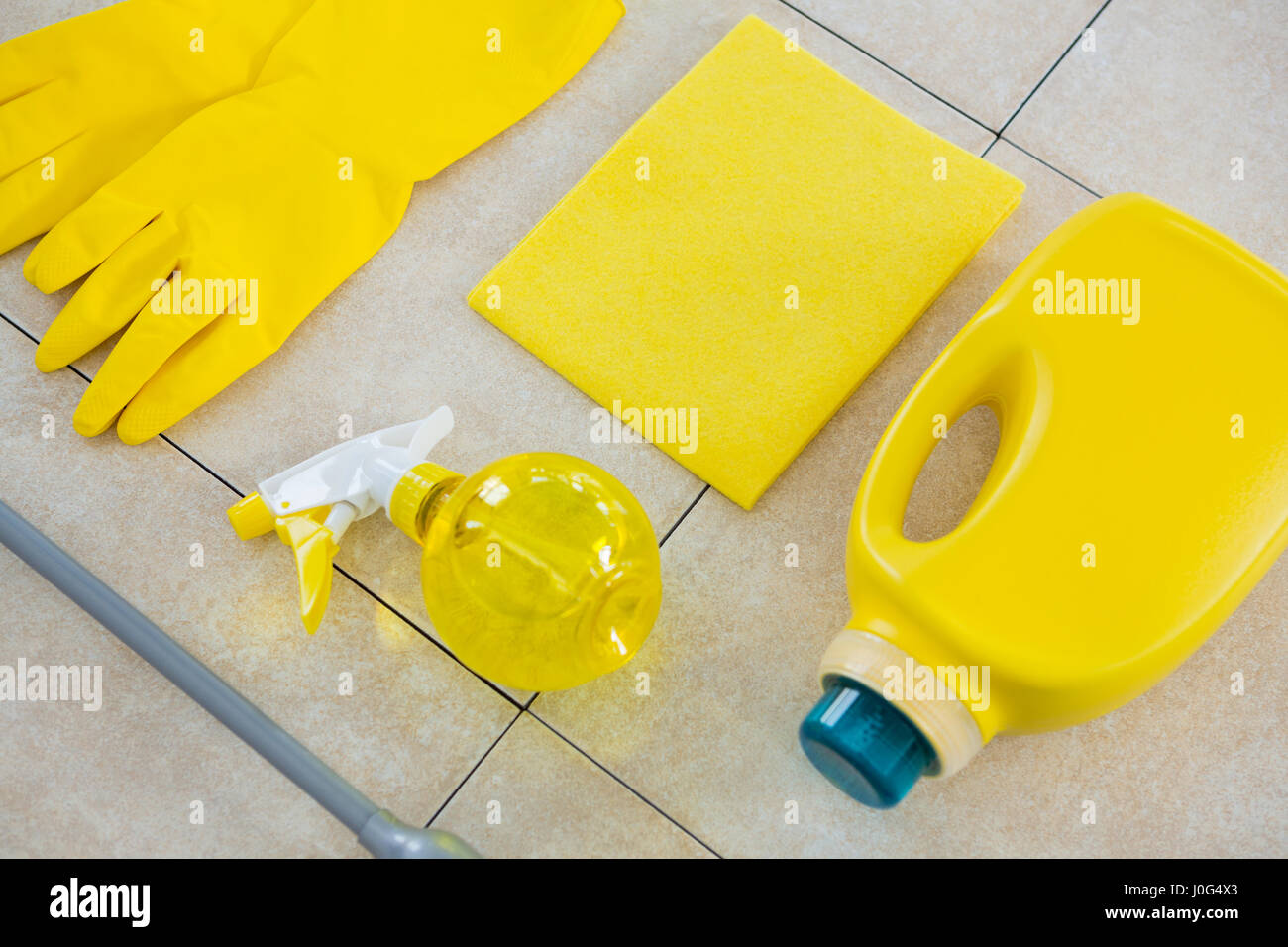 Close up of yellow cleaning equipment on tiled floor Stock Photo - Alamy