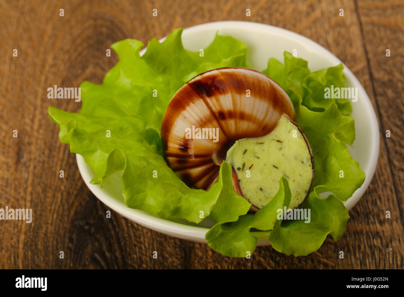 Escargot with cheese cream on salad leaves Stock Photo - Alamy