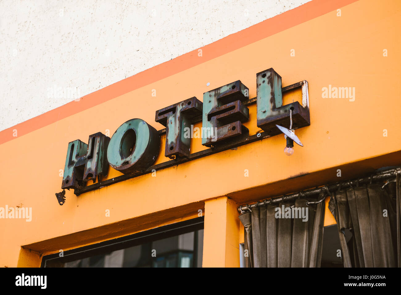 Old rusty metal hotel sign Stock Photo - Alamy