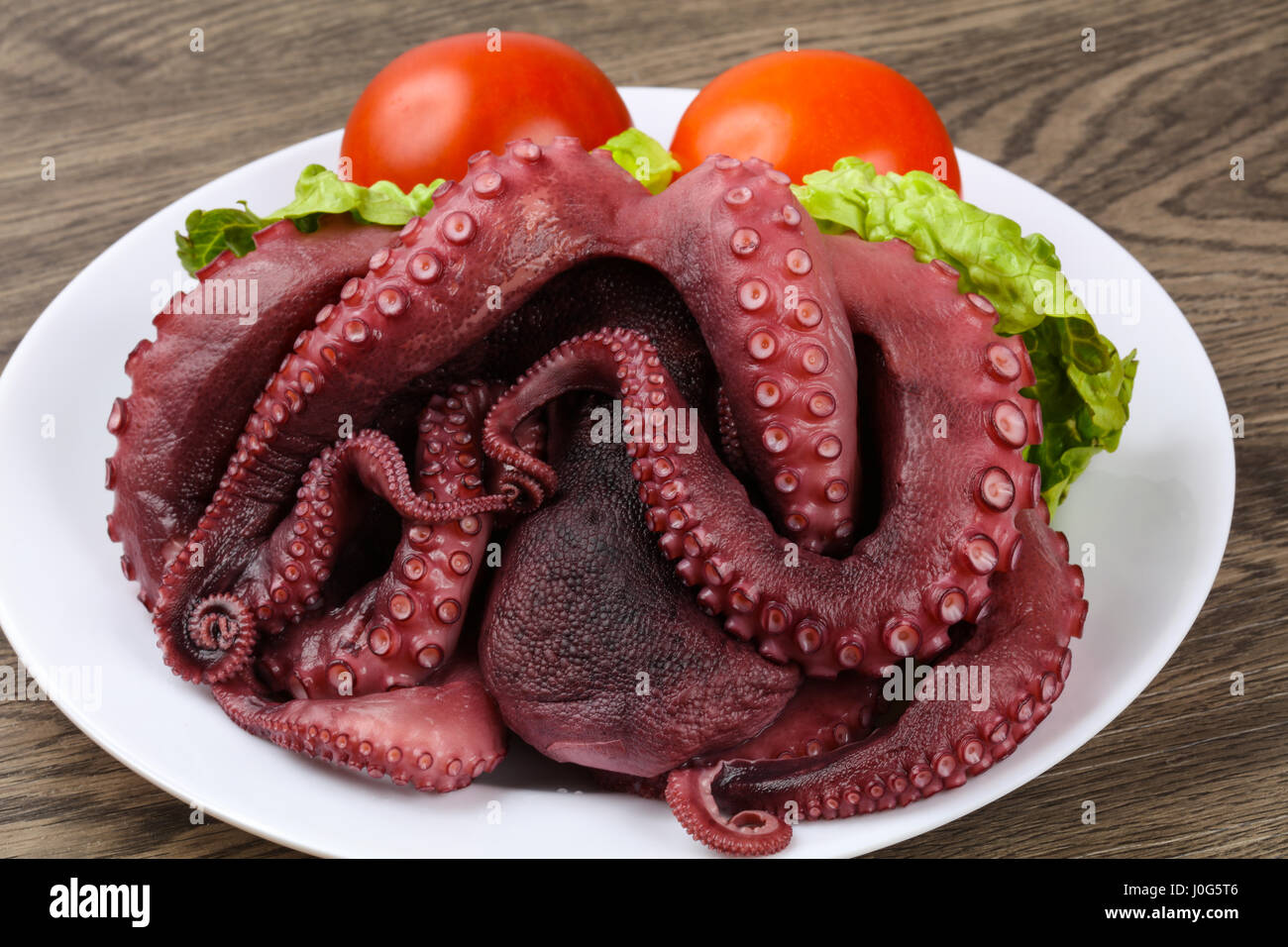 Boiled octopus ready for eat with salad leaves Stock Photo - Alamy