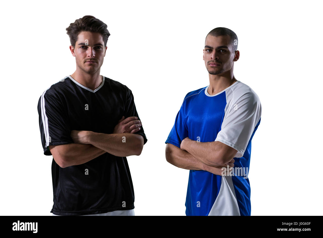 Two football players standing with arms crossed against white ...