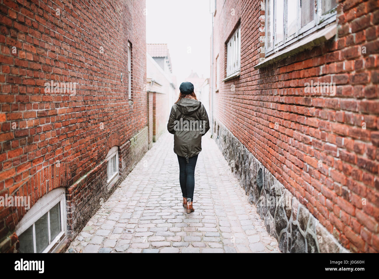 Woman walking in the street photographed from behind Stock Photo - Alamy
