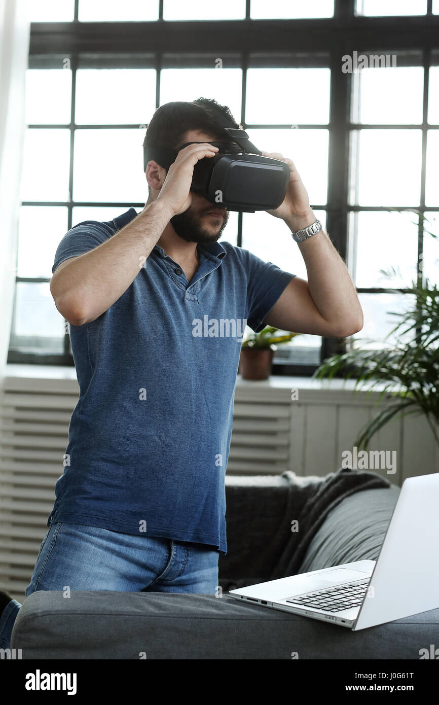 Technology. Man with VR headset at home Stock Photo - Alamy