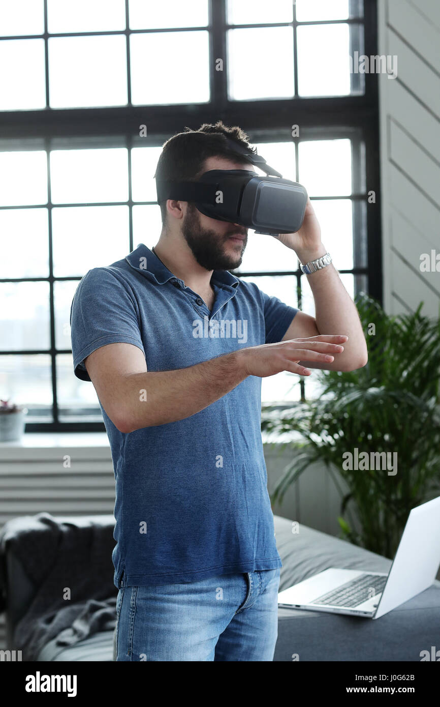 Technology. Man with VR headset at home Stock Photo - Alamy