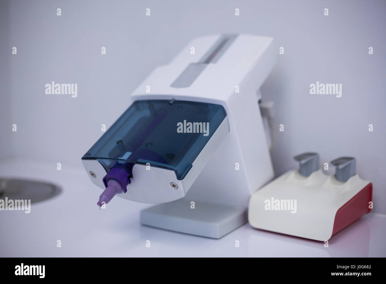 Close-up of dental impression material mixing machine at dental clinic ...